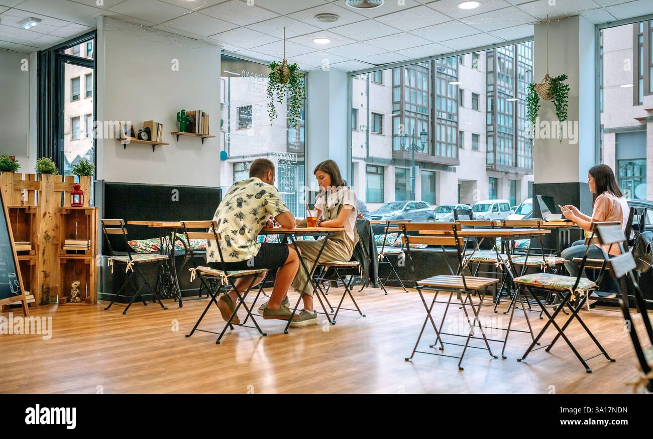 Customers enjoying relaxing atmosphere in modern cafe Stock Photo - Alamy