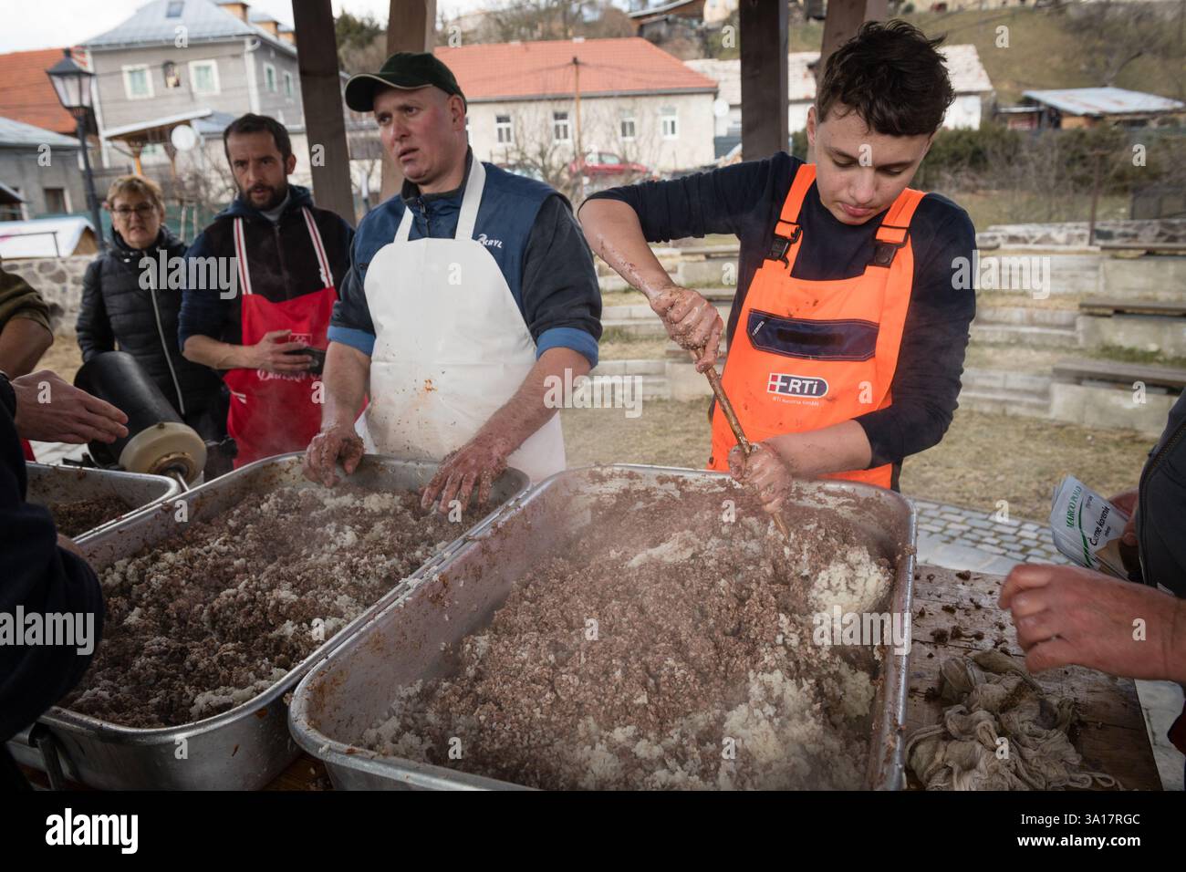 BANSKA BELA, SLOVAKIA - MAR 1, 2025: People processing ground pork meat ...