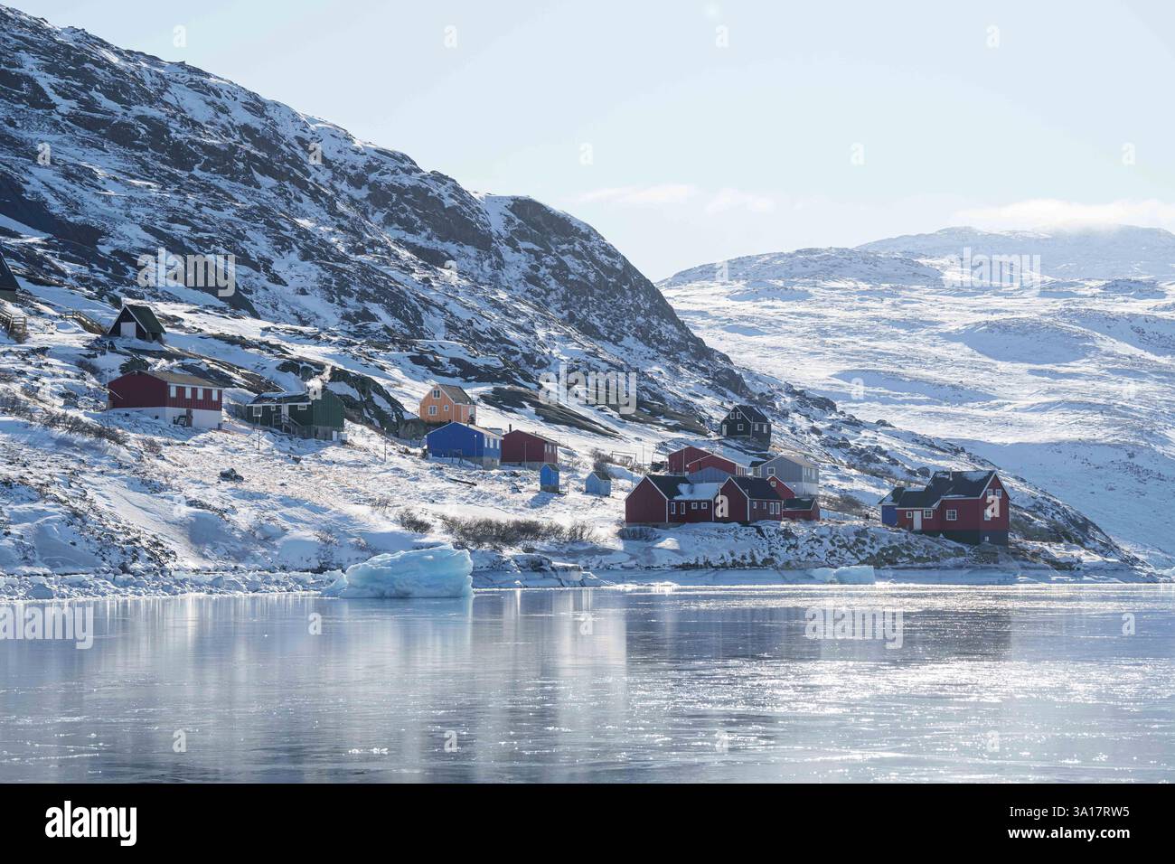 The Kapisillit village is seen from a frozen seat inlet in Greenland ...
