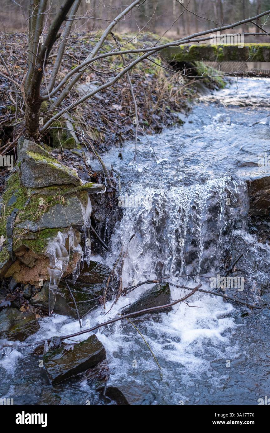 Small waterfall in forest creek with ice formations Stock Photo - Alamy