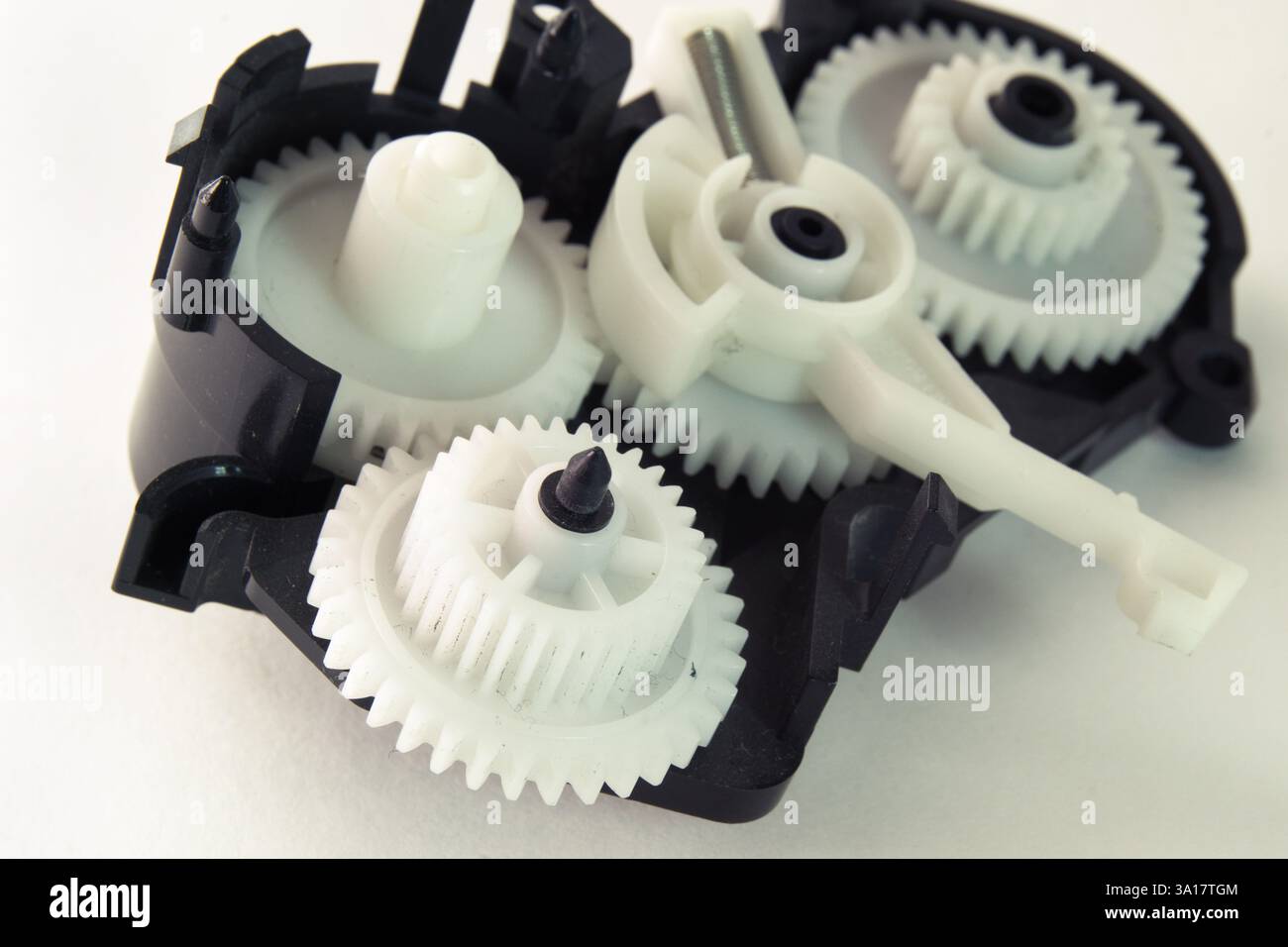 white plastic spur gears connected in complex mechanism, part of the ...