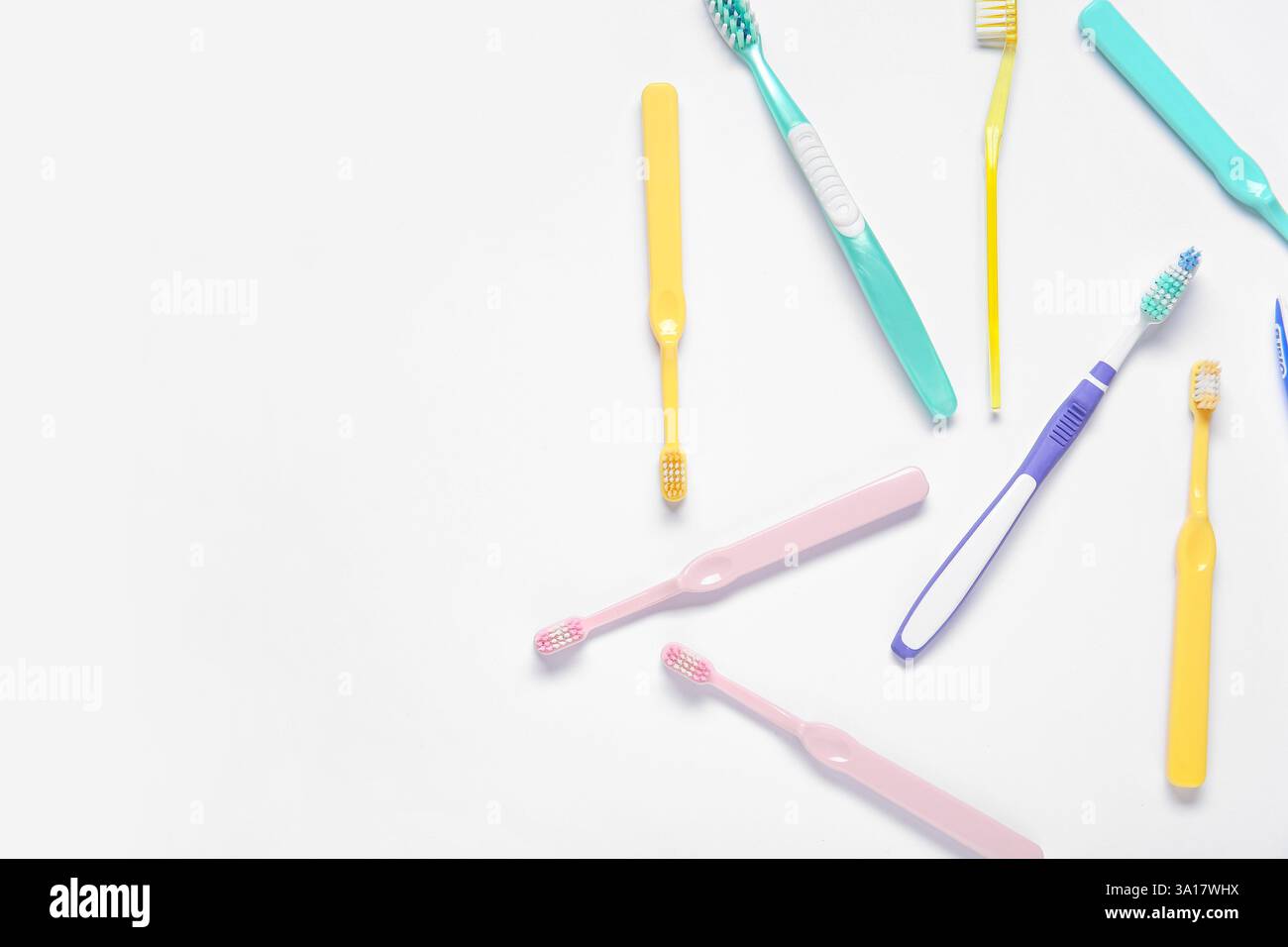 Colorful plastic toothbrushes on white background Stock Photo - Alamy