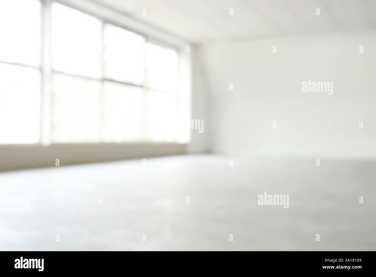 Blurred view of big empty room with large window Stock Photo - Alamy