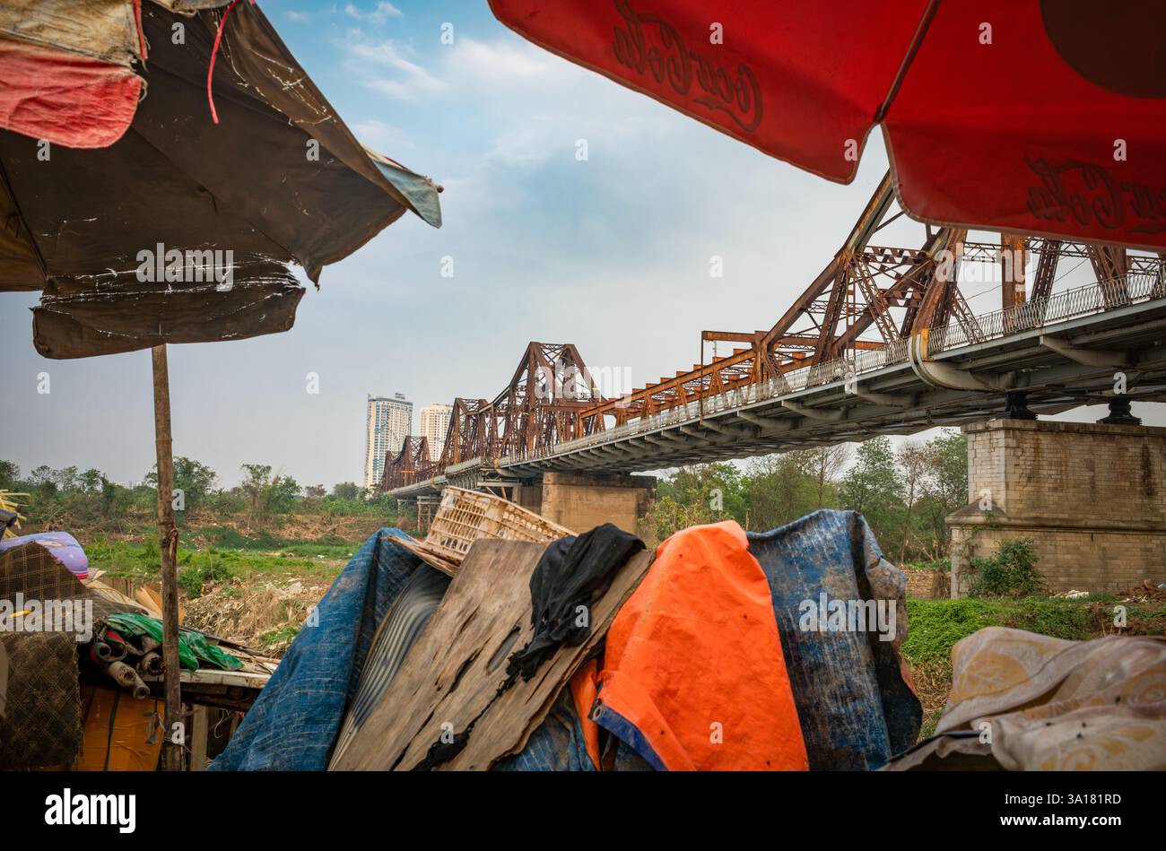 Long Bien bridge seen from the shanty town community of slums next to ...
