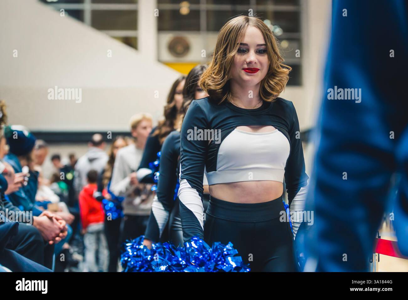 Cheerleaders Performing Dance Routine in Modern Sports Arena with ...