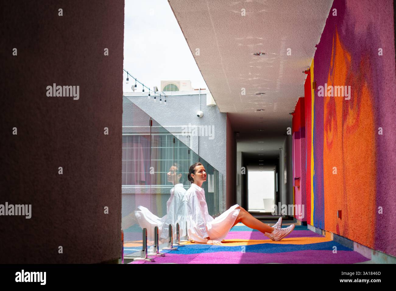 A Vibrant Corridor Featuring a Model Showcasing a Modern and Chic Aesthetic Design in Venice ...