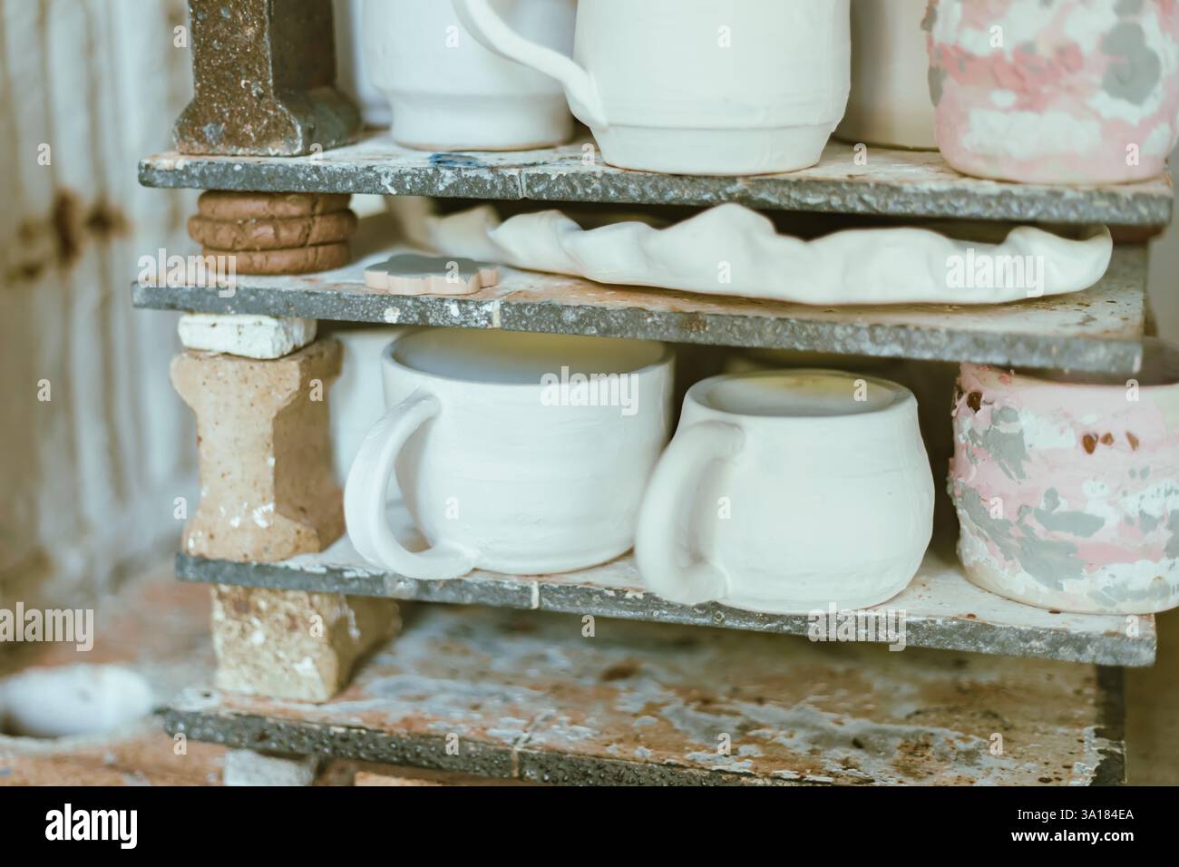 clay mugs in kiln for firing pottery in pottery studio Stock Photo - Alamy