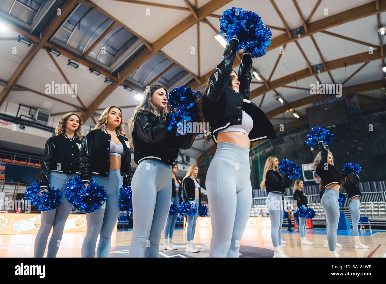 Cheerleaders Performing Dance Routine in Modern Sports Arena with ...