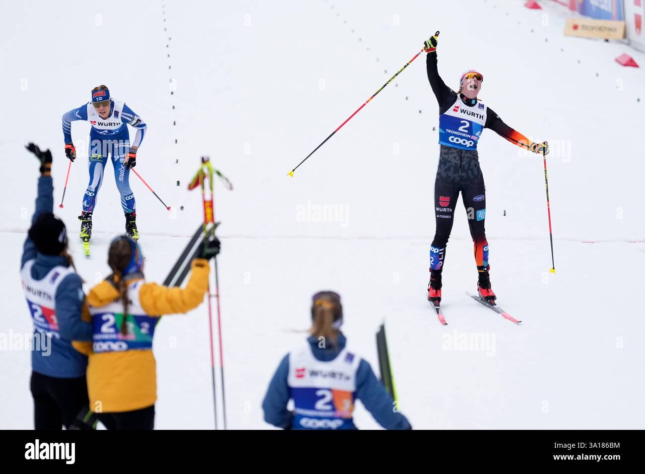 Victoria Carl, of Germany, right, crosses the finish line ahead of ...