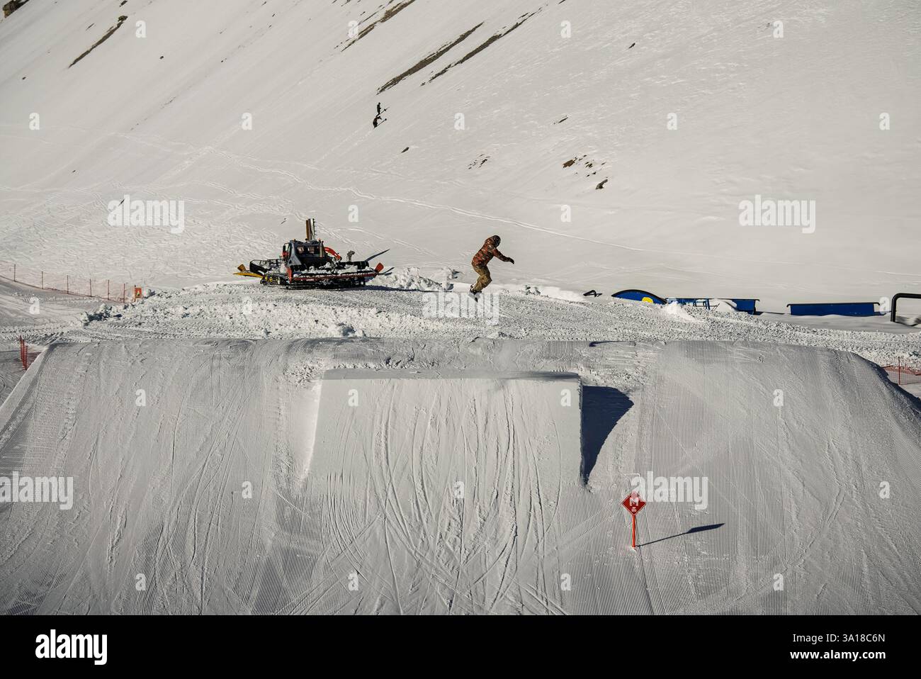 Snow covered jump ramp, kicker in a winter landscape with soft lighting ...