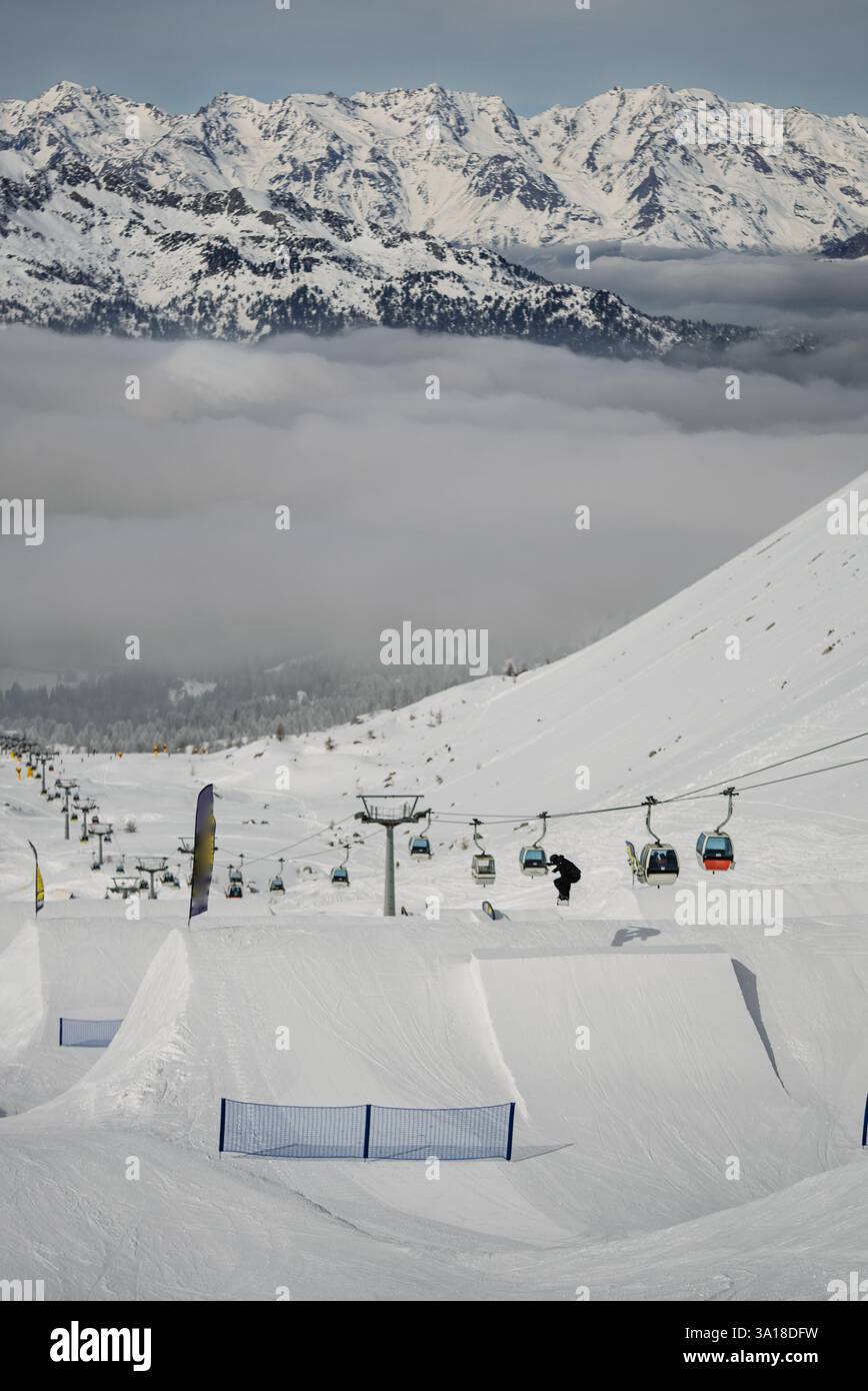 Snow covered jump ramp, kicker in a winter landscape with soft lighting ...