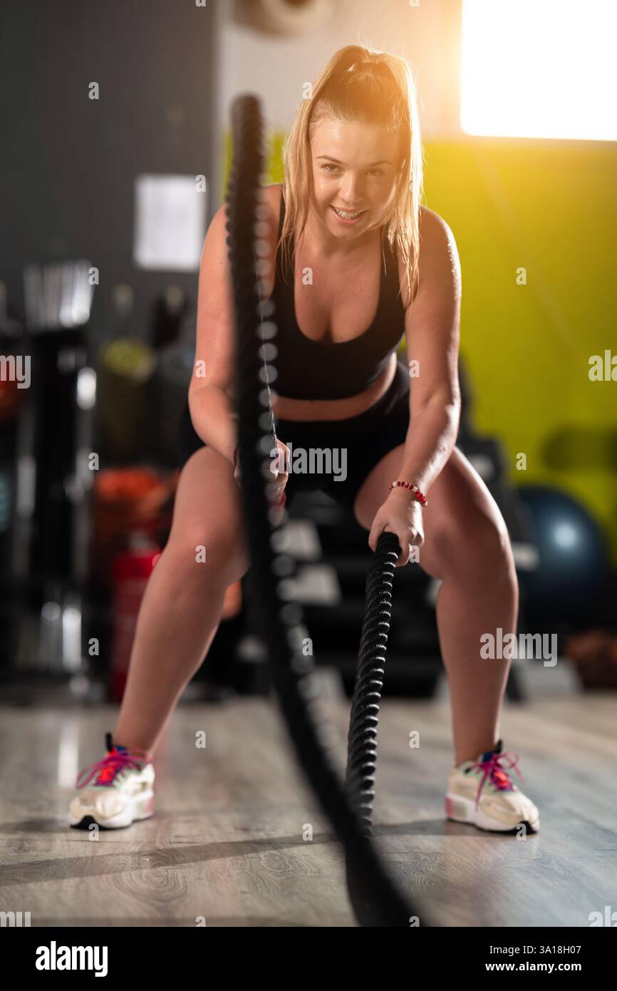 Fit Woman Performing Rope Conditioning Exercise in the Gym Stock Photo ...