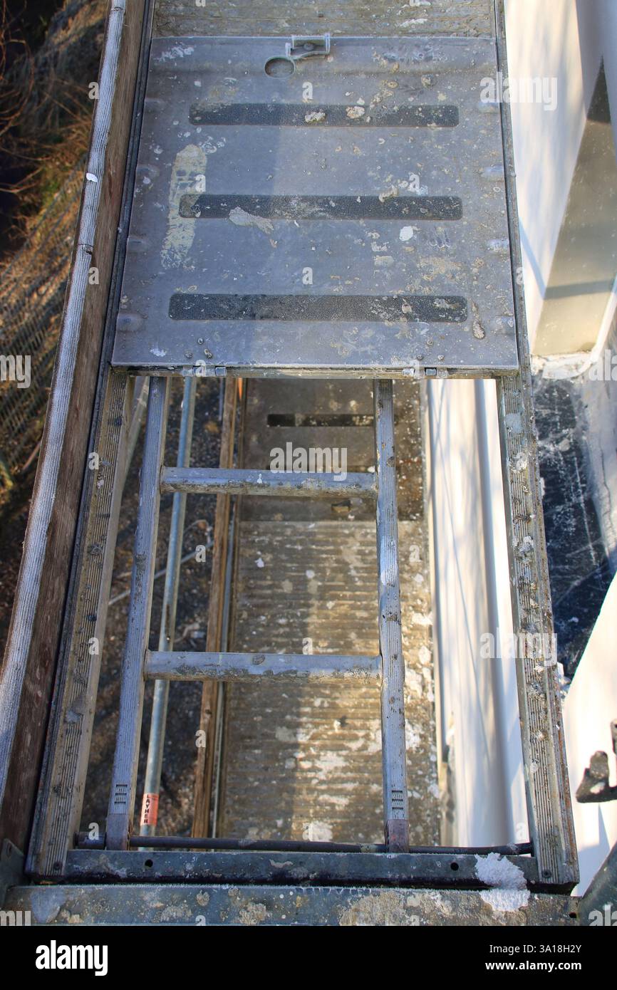 Open lid on a ladder on a scaffold Stock Photo - Alamy