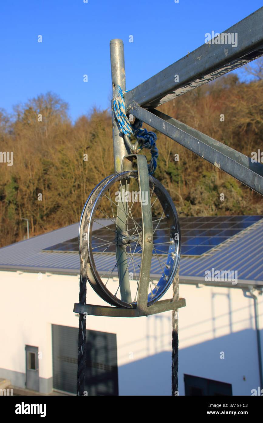 Round roller on a construction site is attached to a carrier with a ...