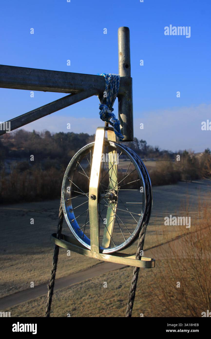 Round roller on a construction site is attached to a carrier with a ...