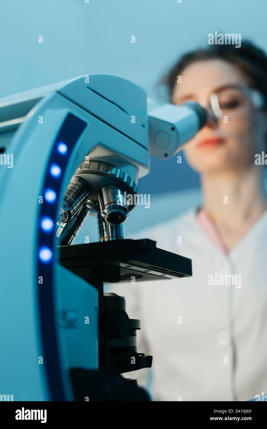 A young female scientist conducts research in a medical lab, using a ...