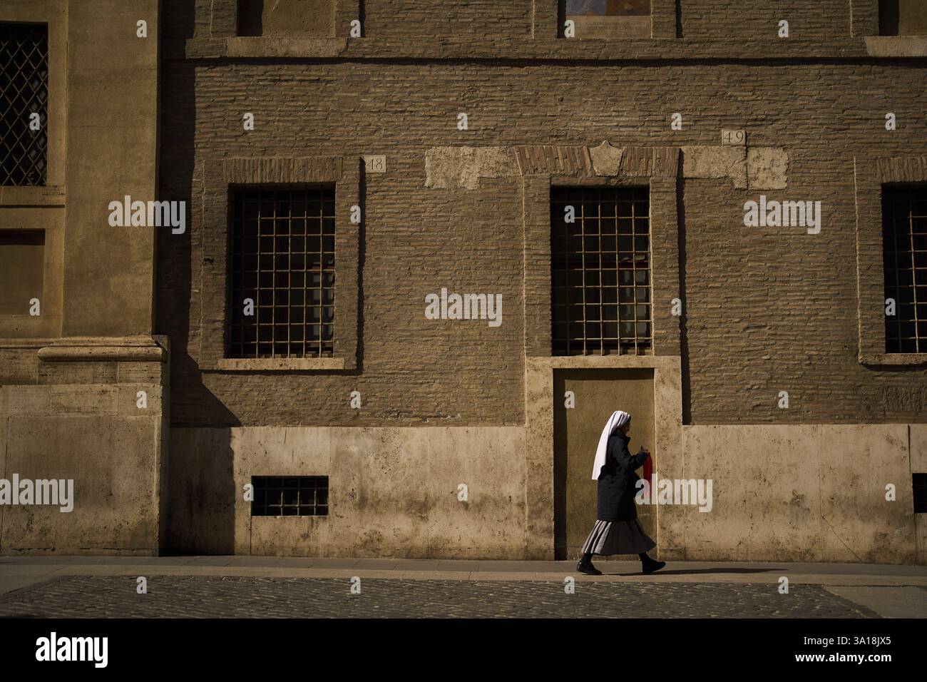 A catholic nun walks at the Vatican city, in Rome, Italy, Friday, March ...