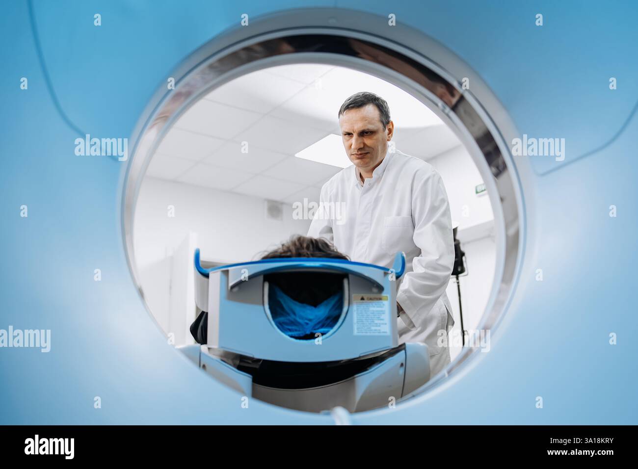 A dedicated doctor completes an MRI examination while engaging with a ...