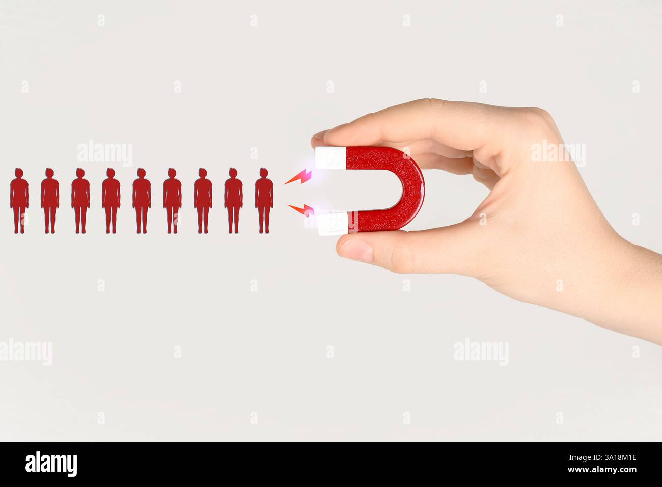 Woman attracting red human figures with magnet on white background ...