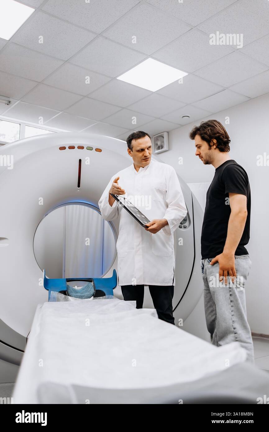 A dedicated doctor completes an MRI examination while engaging with a ...