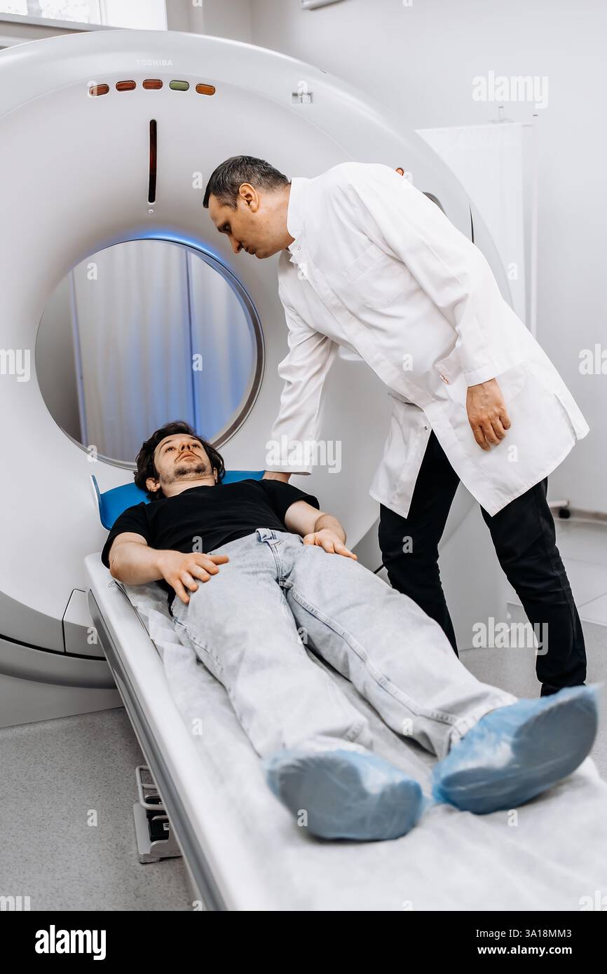 A dedicated doctor completes an MRI examination while engaging with a ...