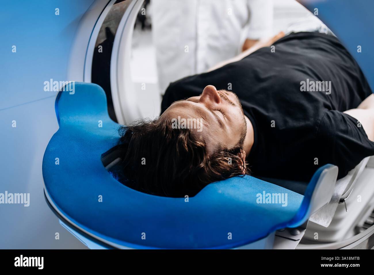The patient lies inside an MRI or CT machine where the scan is performed. This high-tech ...