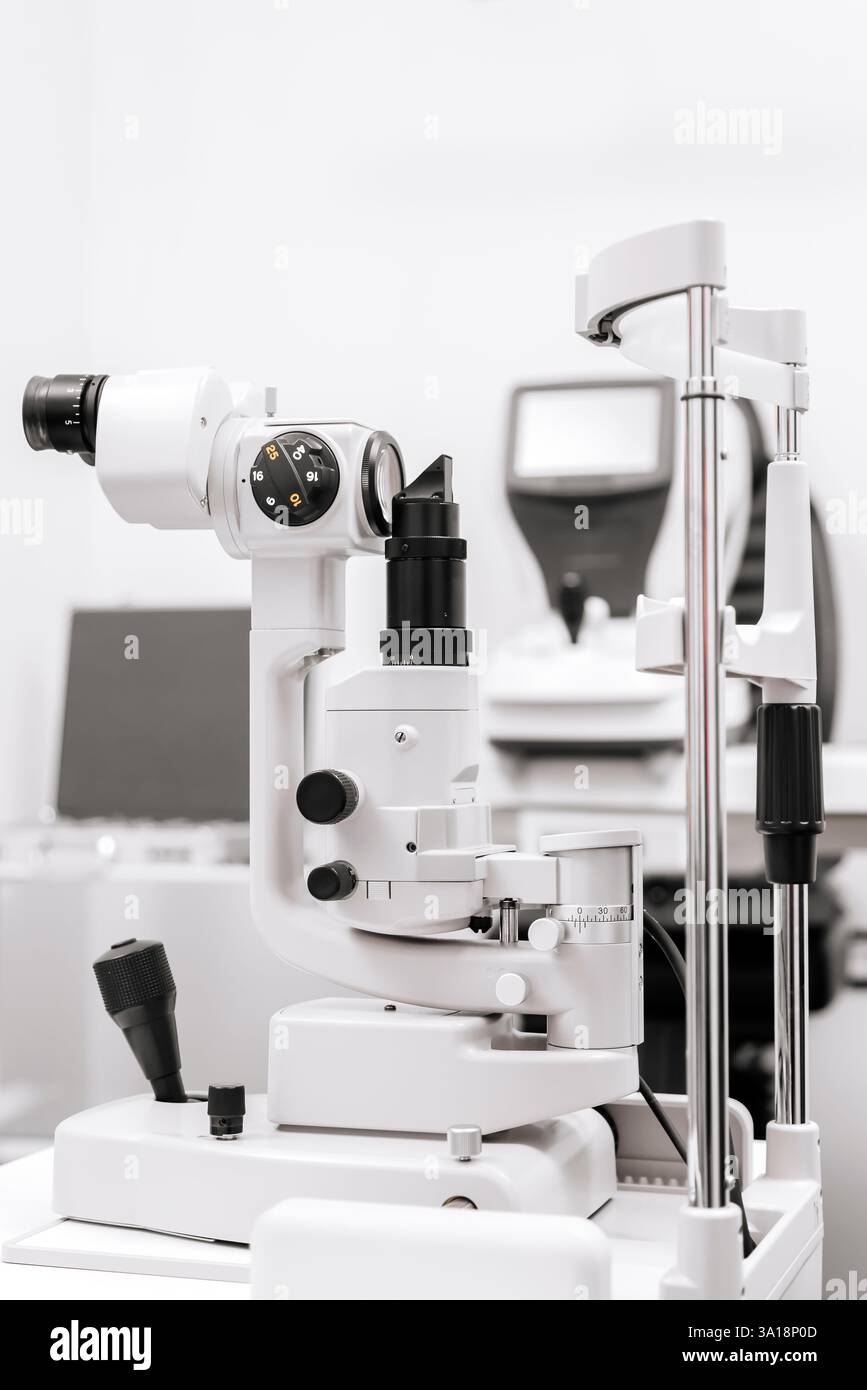 Close-up of a slit lamp against a white background in an ...
