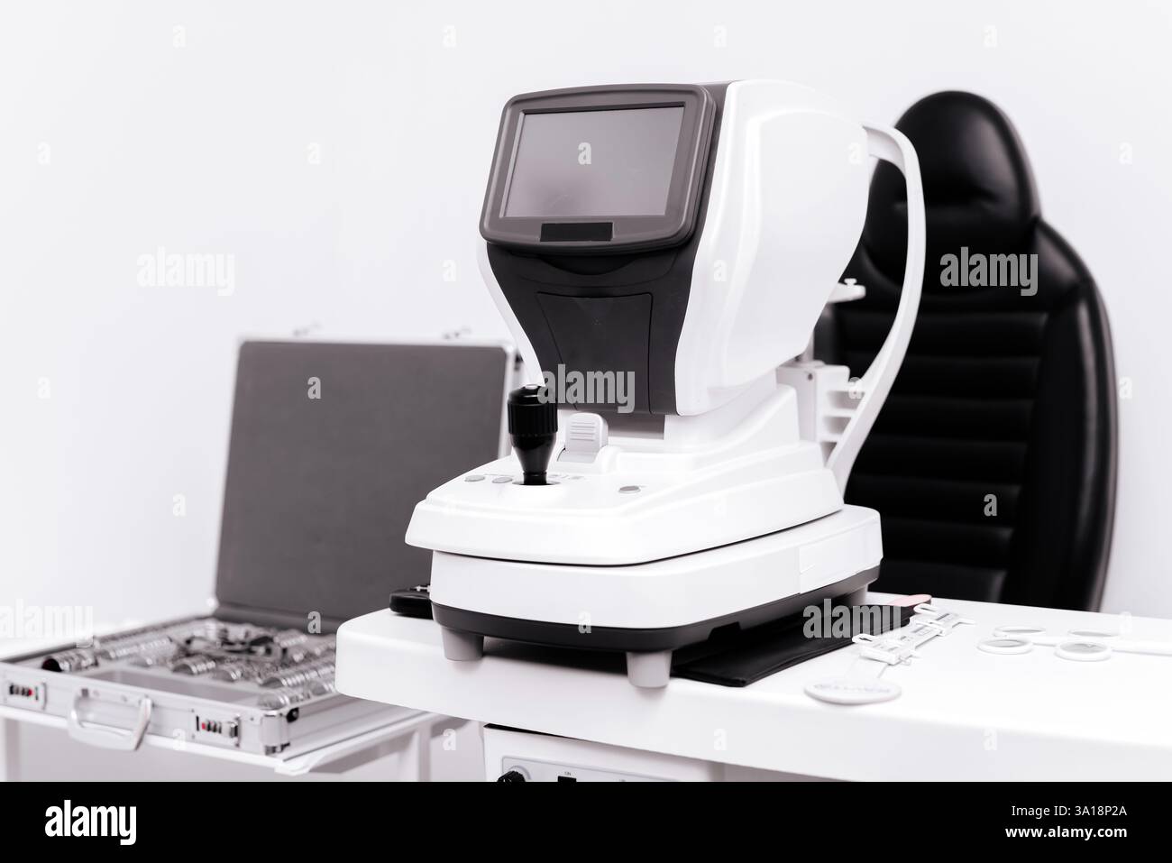 Close-up of a slit lamp against a white background in an ...