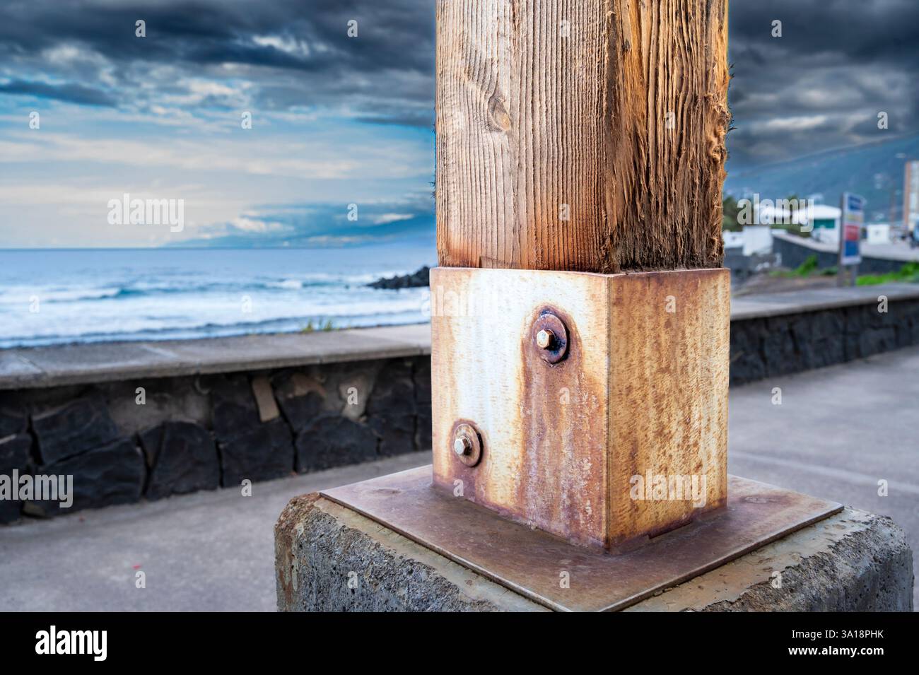 A rusty metal pole is leaning against a stone wall Stock Photo - Alamy