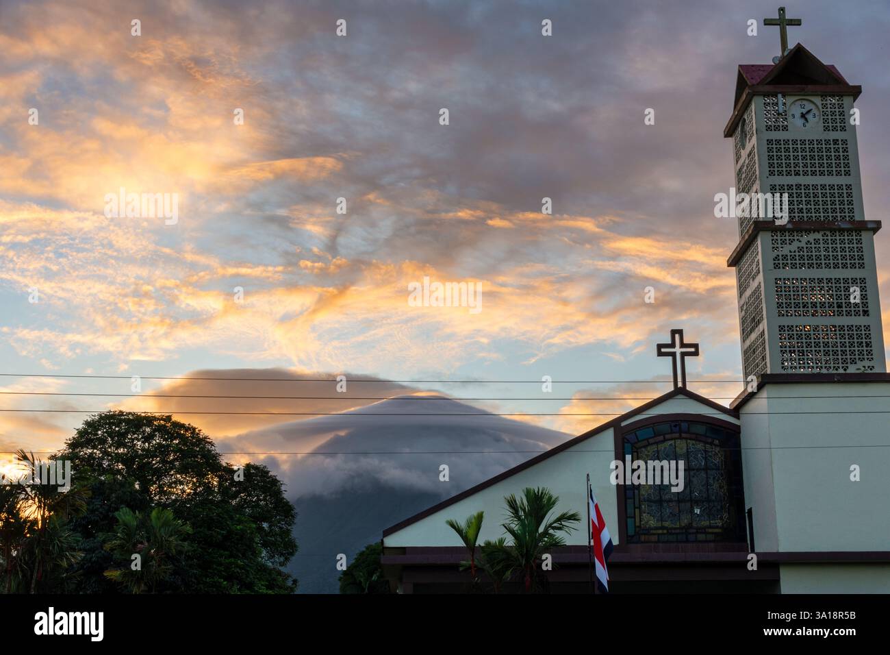Iglesias de La Fortuna with Arenal Volcano at sunset Stock Photo - Alamy