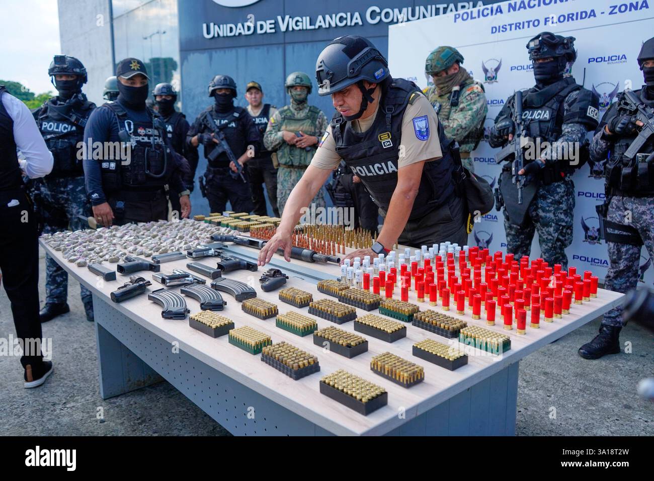 Police display to the press the weapons they say they seized in an ...