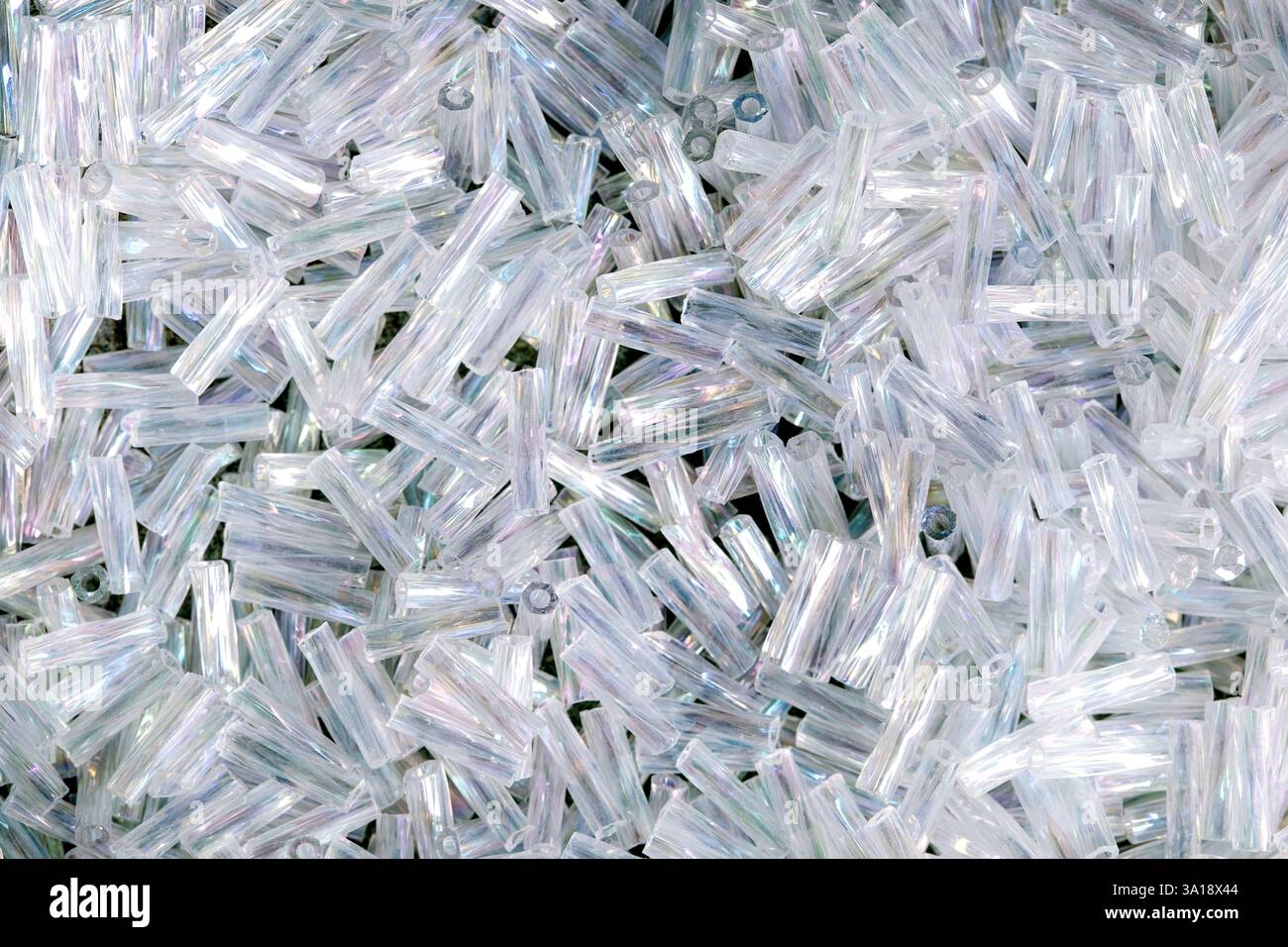 DIY hobby background with white pearlescent glass bugle beads Close-up ...