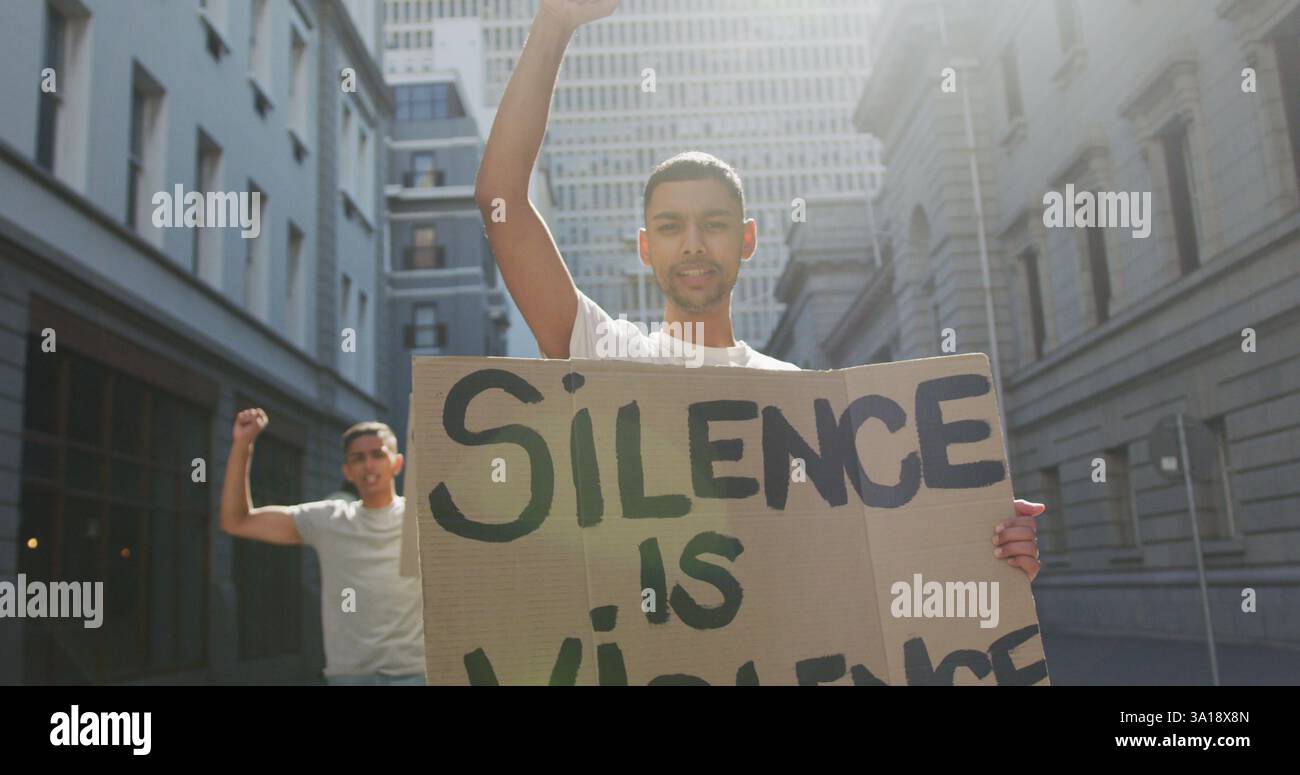Two biracial men on a protest march holding placards raising hands and ...