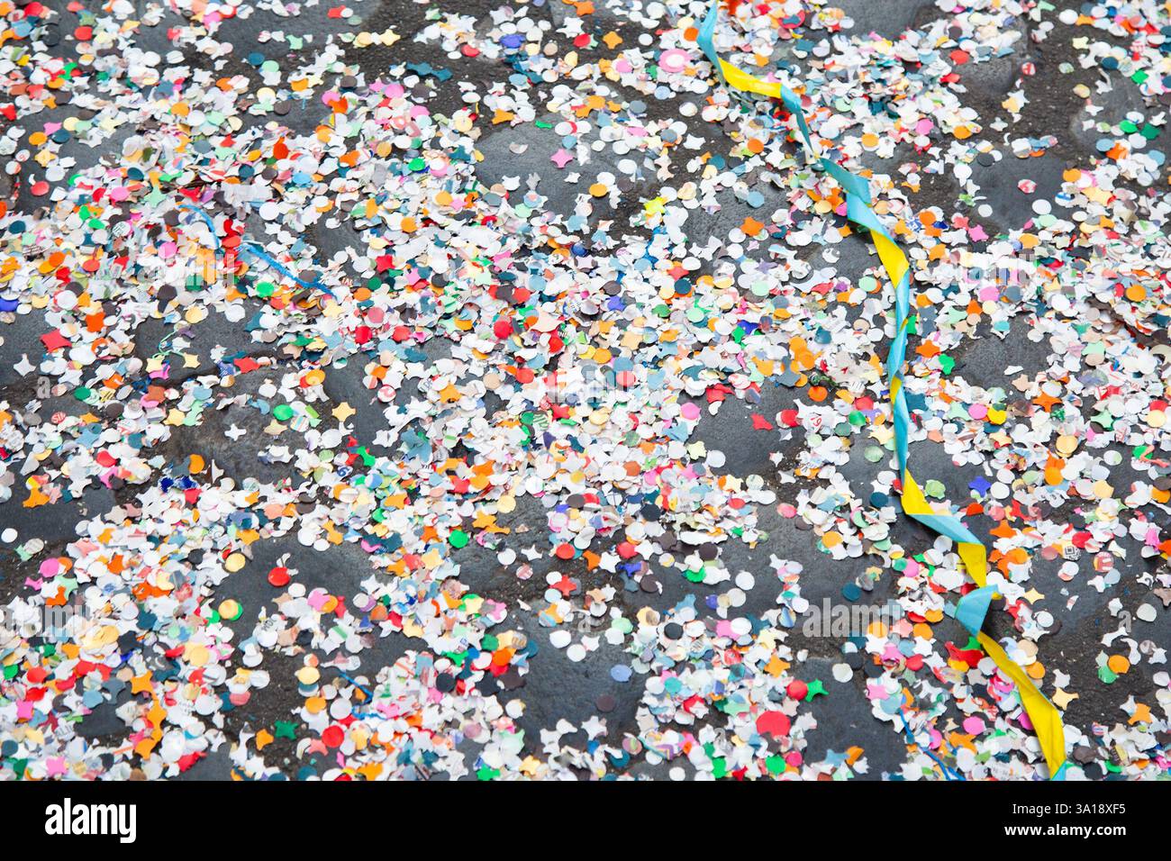 There is a colorful pile of confetti and streamers spread out on the ...