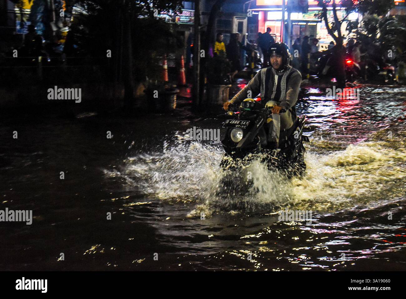 March 7, 2025, Bandung, West Java, Indonesia: A motorcyclist rides ...