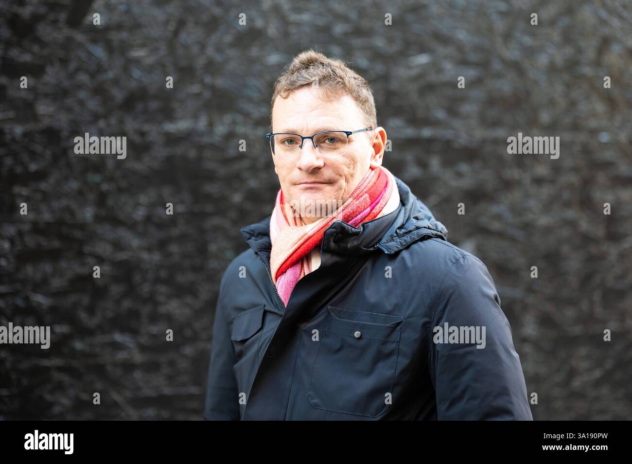 Portrait of a 46 yo white male against a rough black background ...