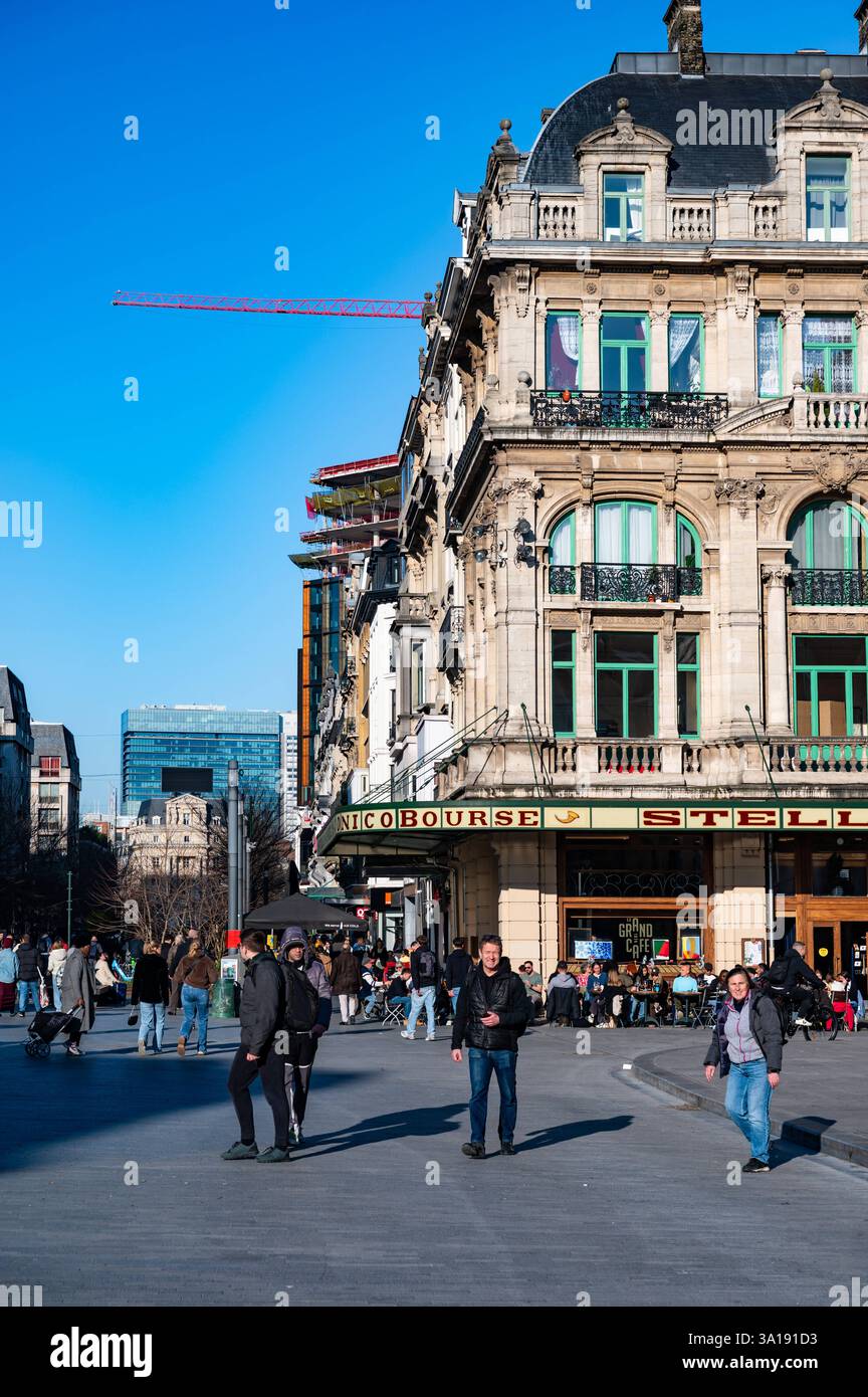 Crowd of people on a sunny day at the Bourse Beurs square in Brussels ...