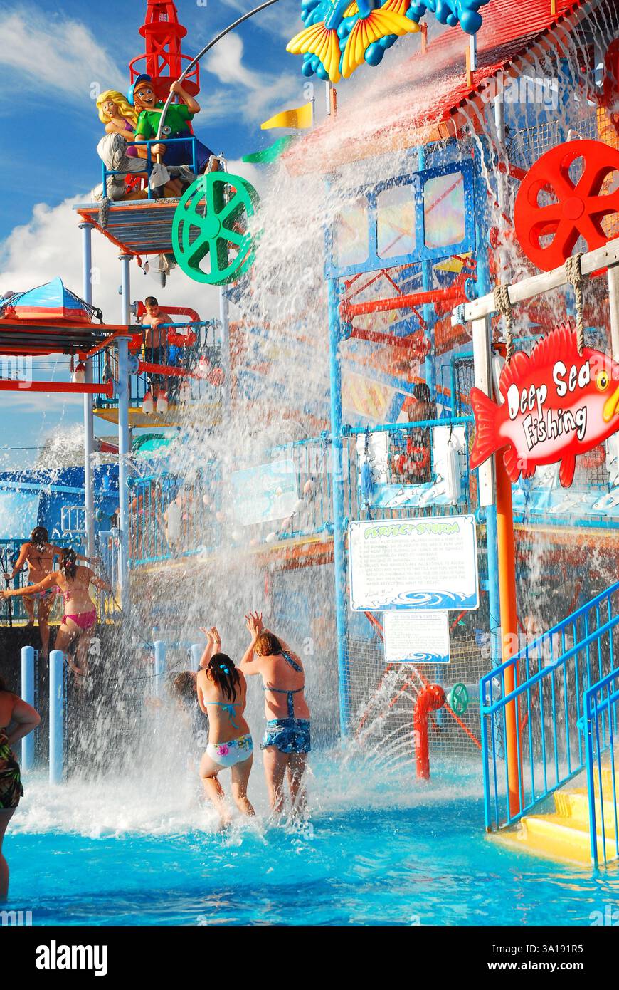 Two girls get dunked at a water with a large bucket of water park Stock ...
