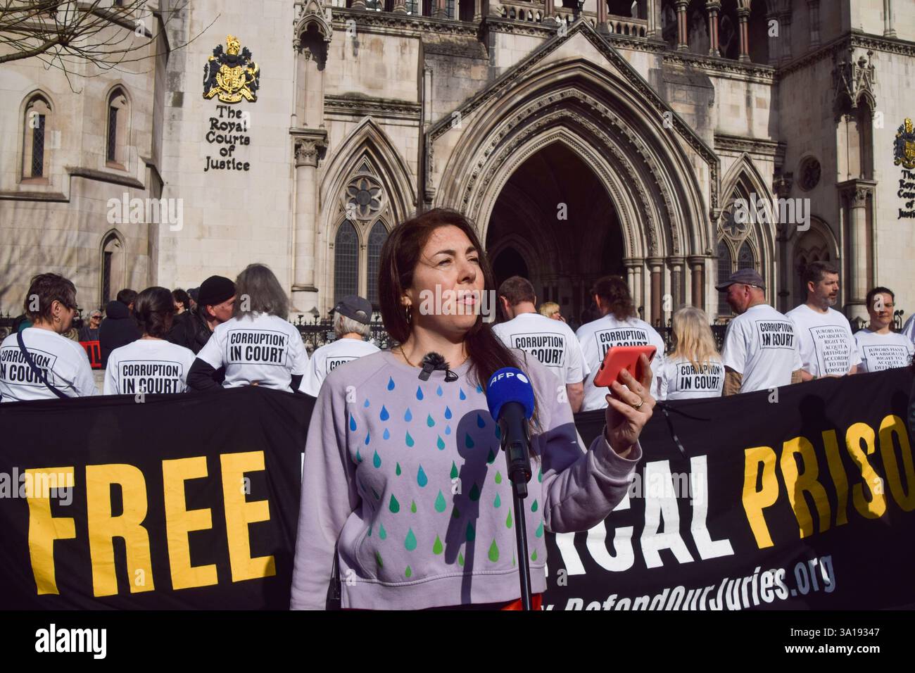 London, UK. 7th March 2025. Climate activists Amy Pritchard reads a ...