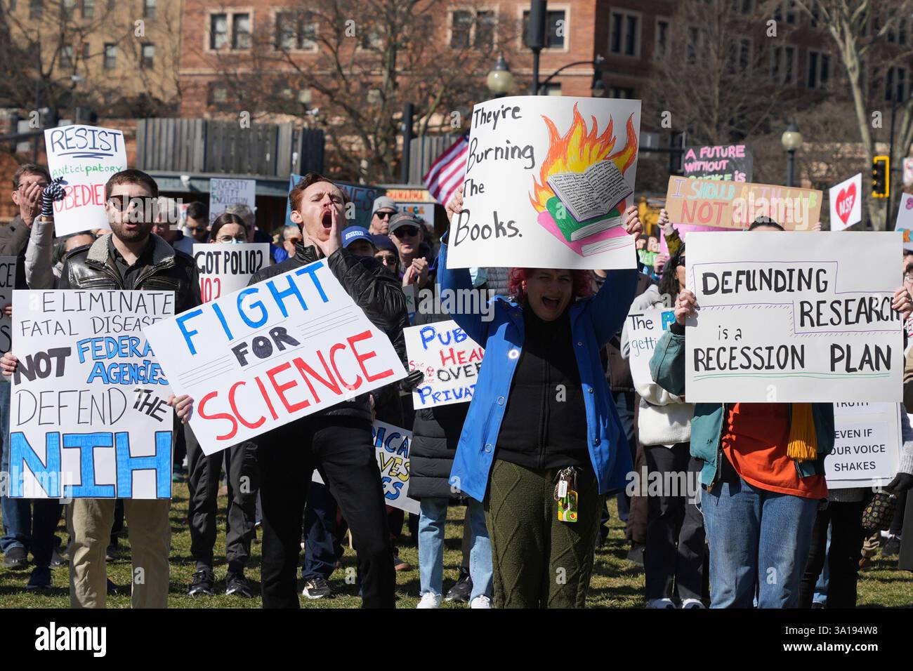 People hold signs during a Stand up for Science rally in Pittsburgh ...