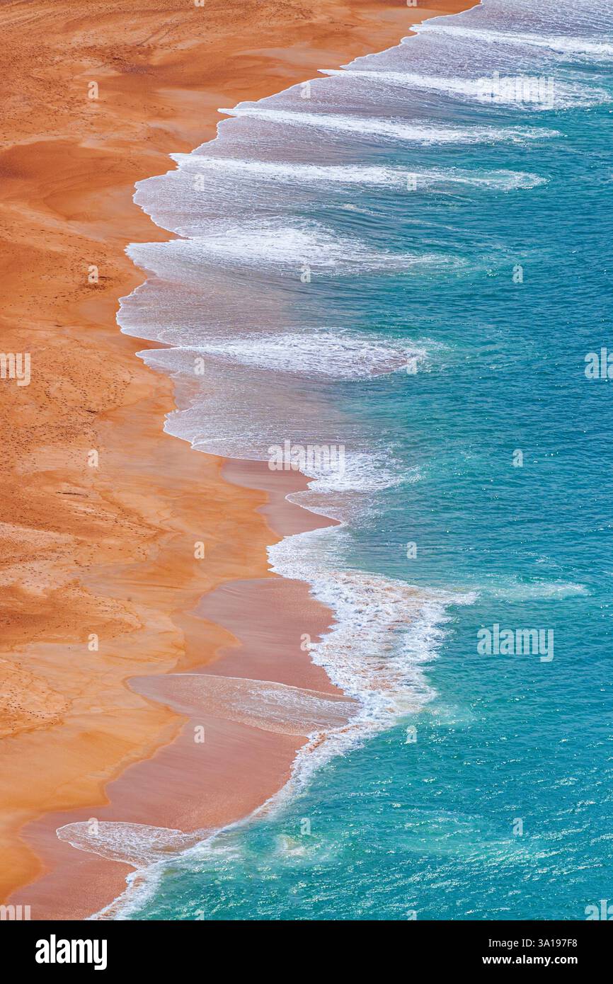 Ocean surf. Waves roll onto the sandy beach. View from above. Natural ...