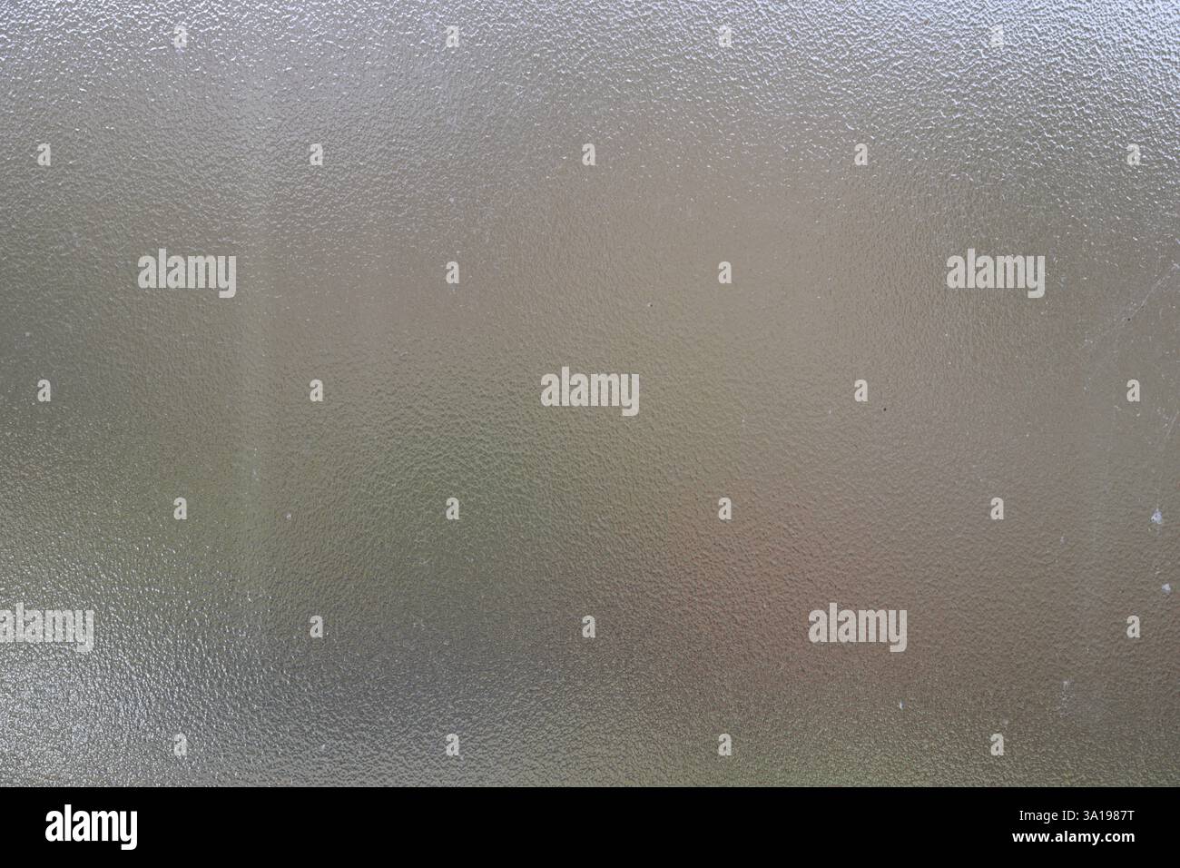 A window with frosted glass, which gives it a hazy, dreamy appearance ...