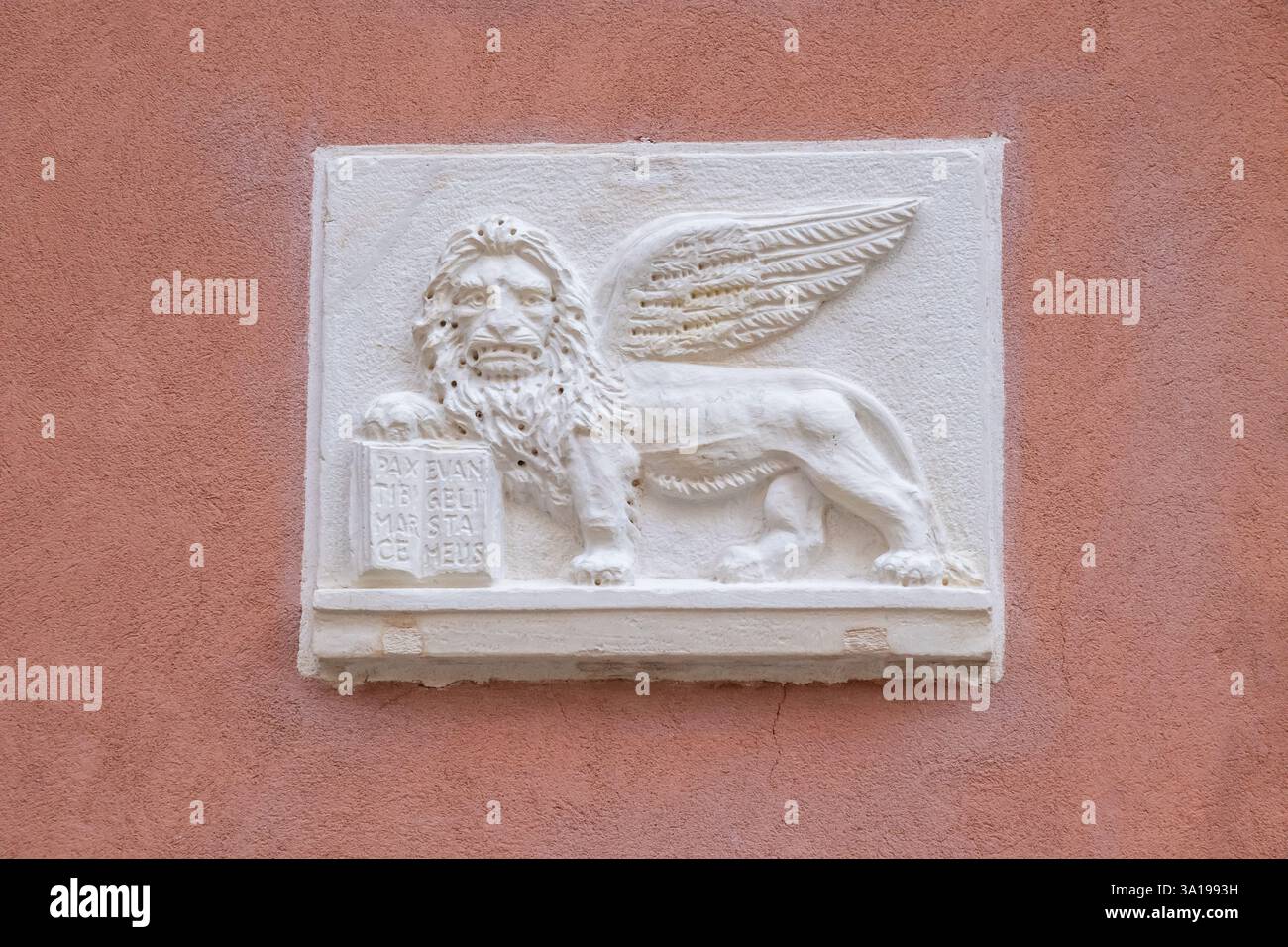 A white stone relief of the Winged Lion of Saint Mark, symbol of Venice ...