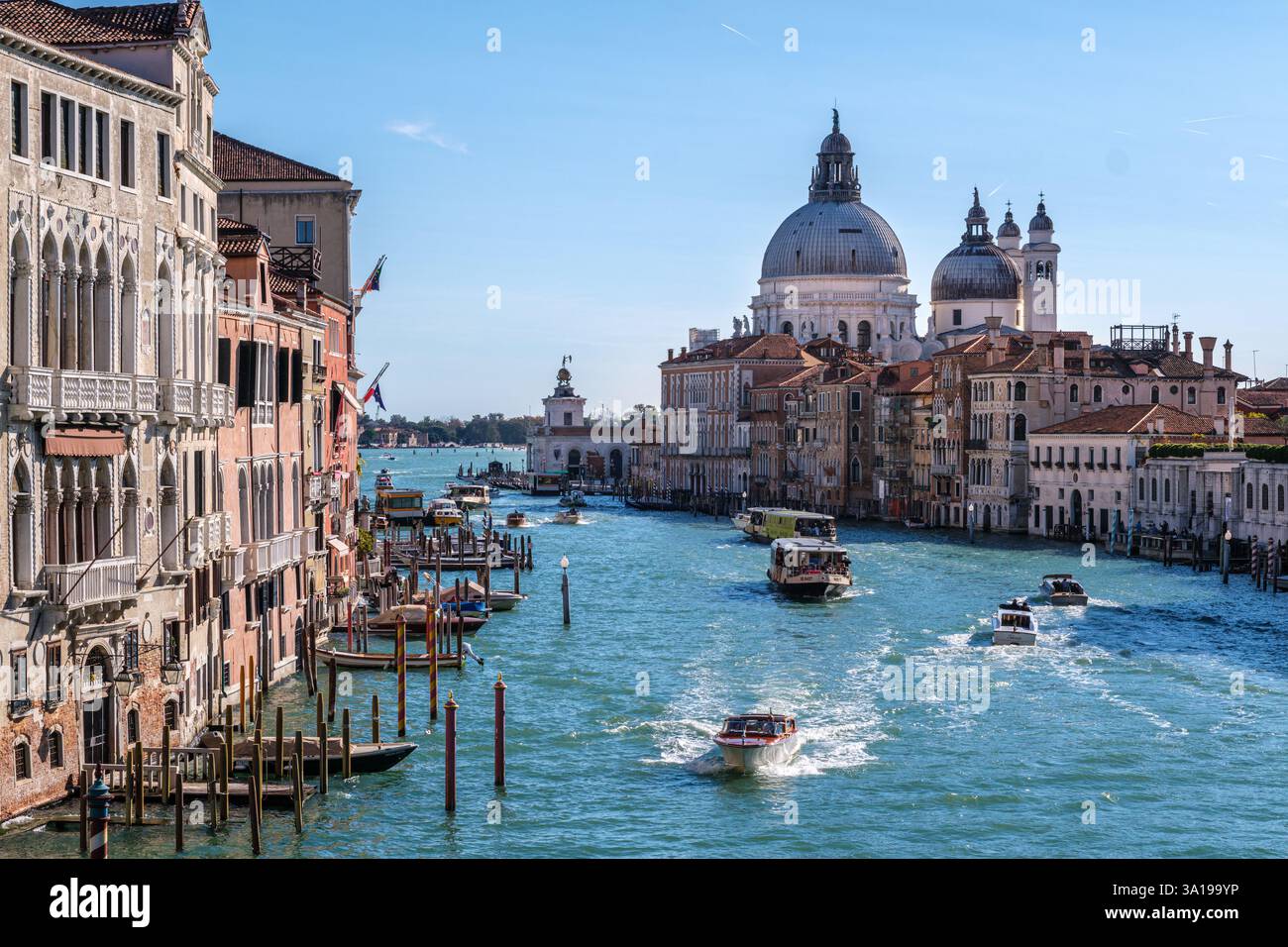 Venice, Italy - 12 October 2024: Boats and gondolas navigate the Grand ...