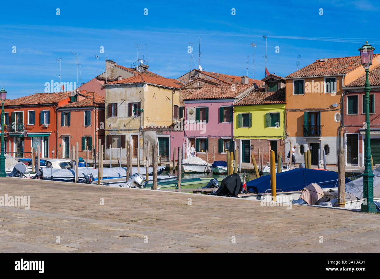 Venice, Italy - 12 October 2024: A row of colorful houses with vibrant ...