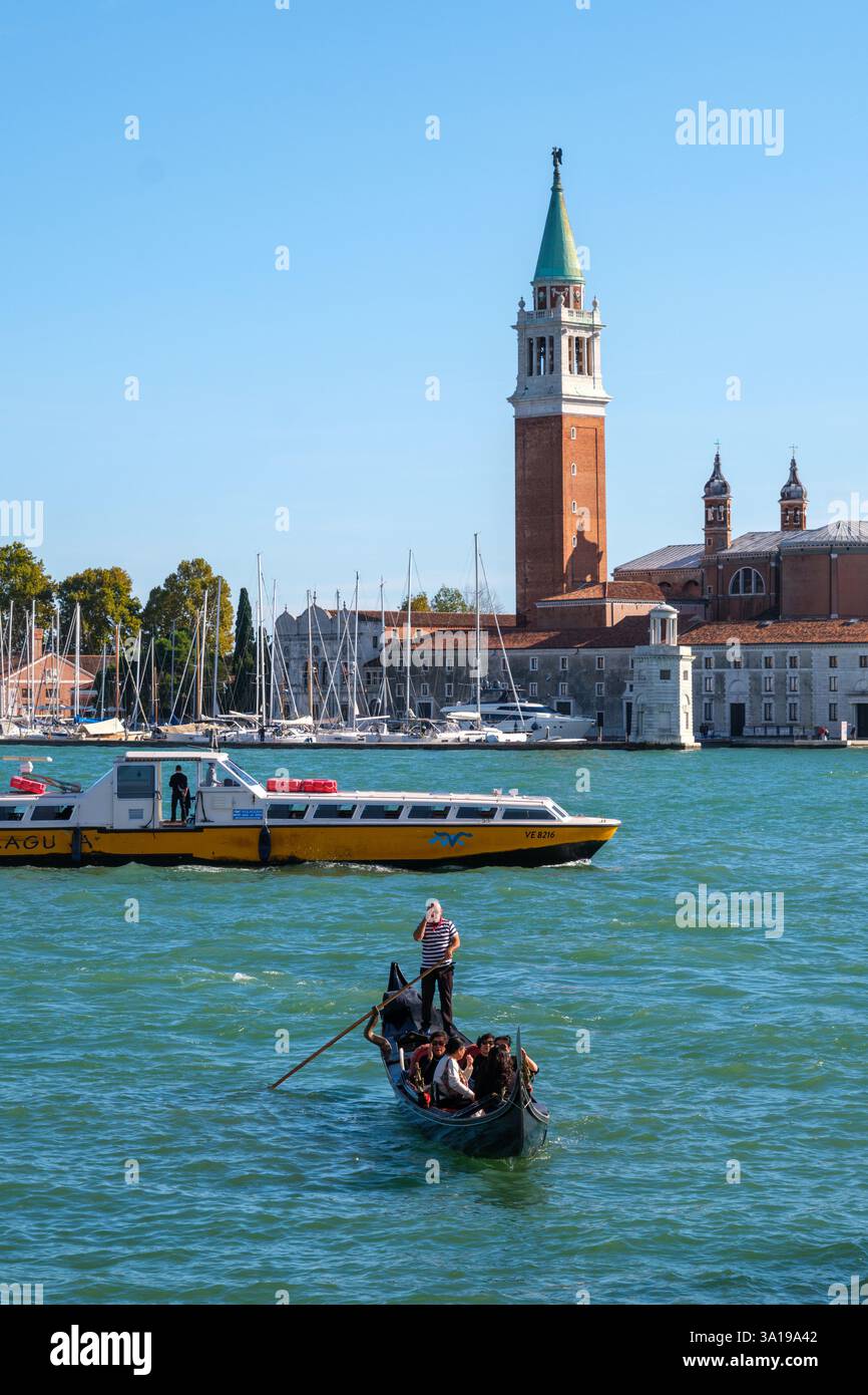Venice, Italy - 12 October 2024: Gondolas and motorboats navigating the ...