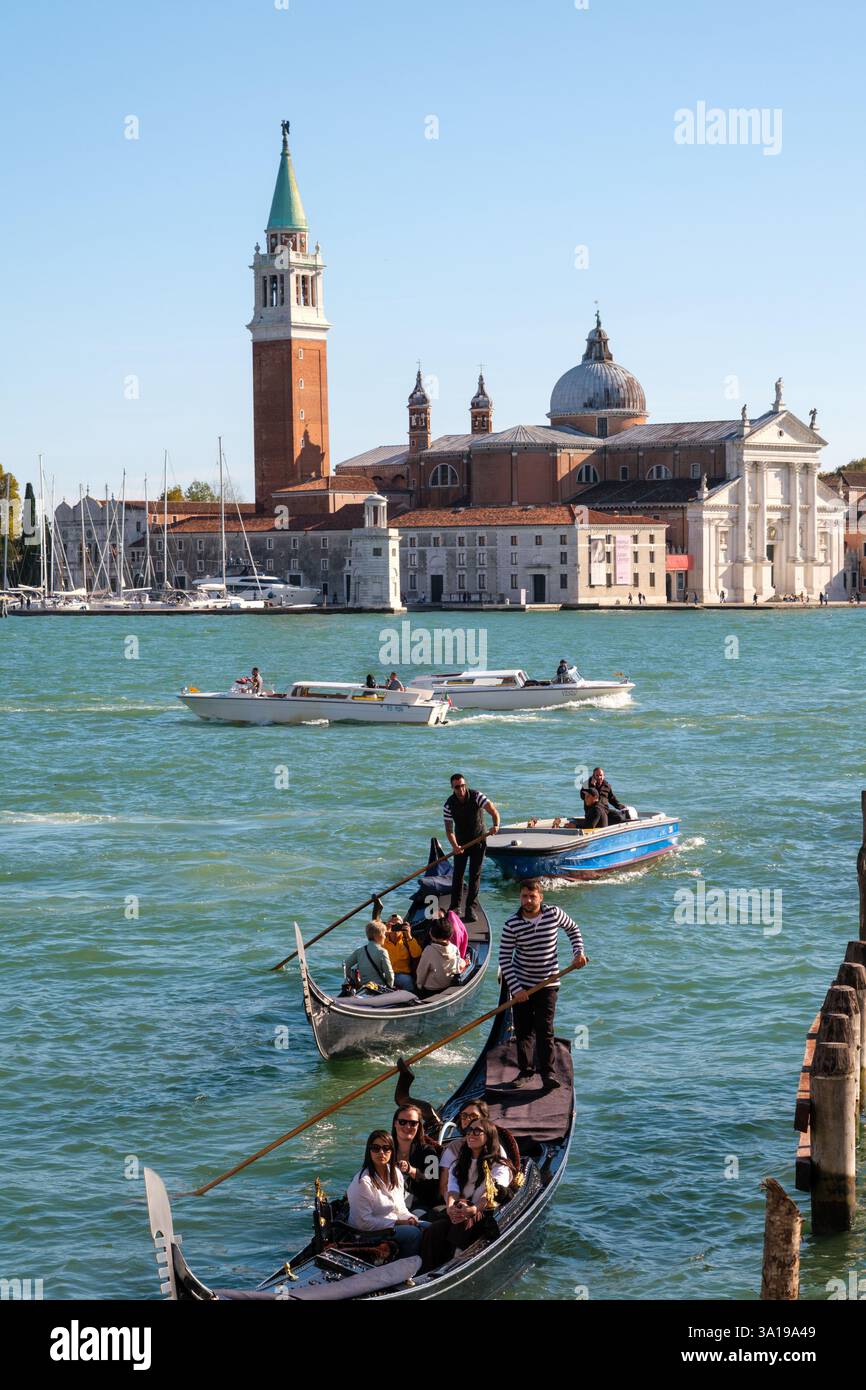Venice, Italy - 12 October 2024: Gondolas and motorboats navigating the ...