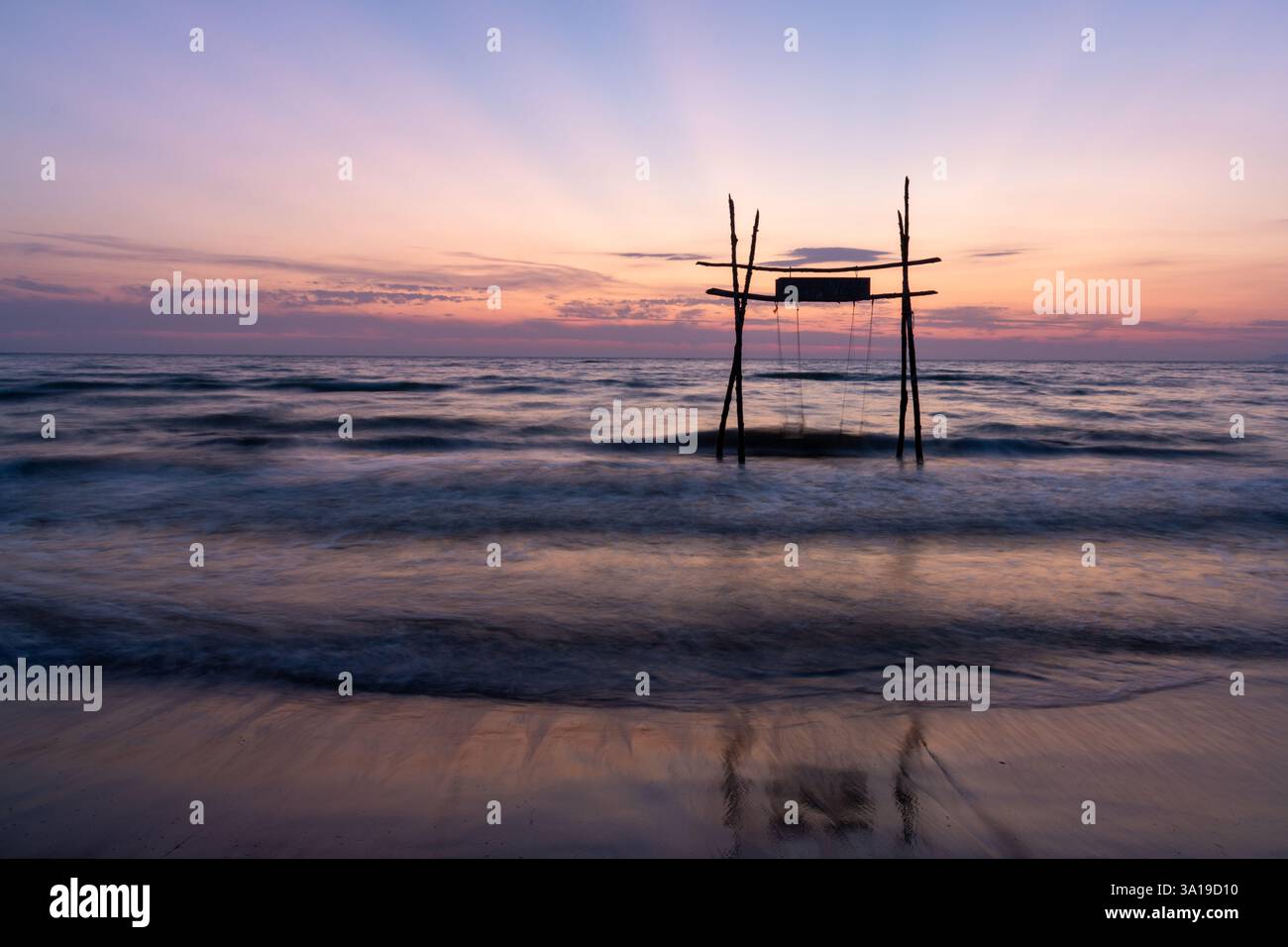 Seaside swing at sunset in Albania Stock Photo - Alamy