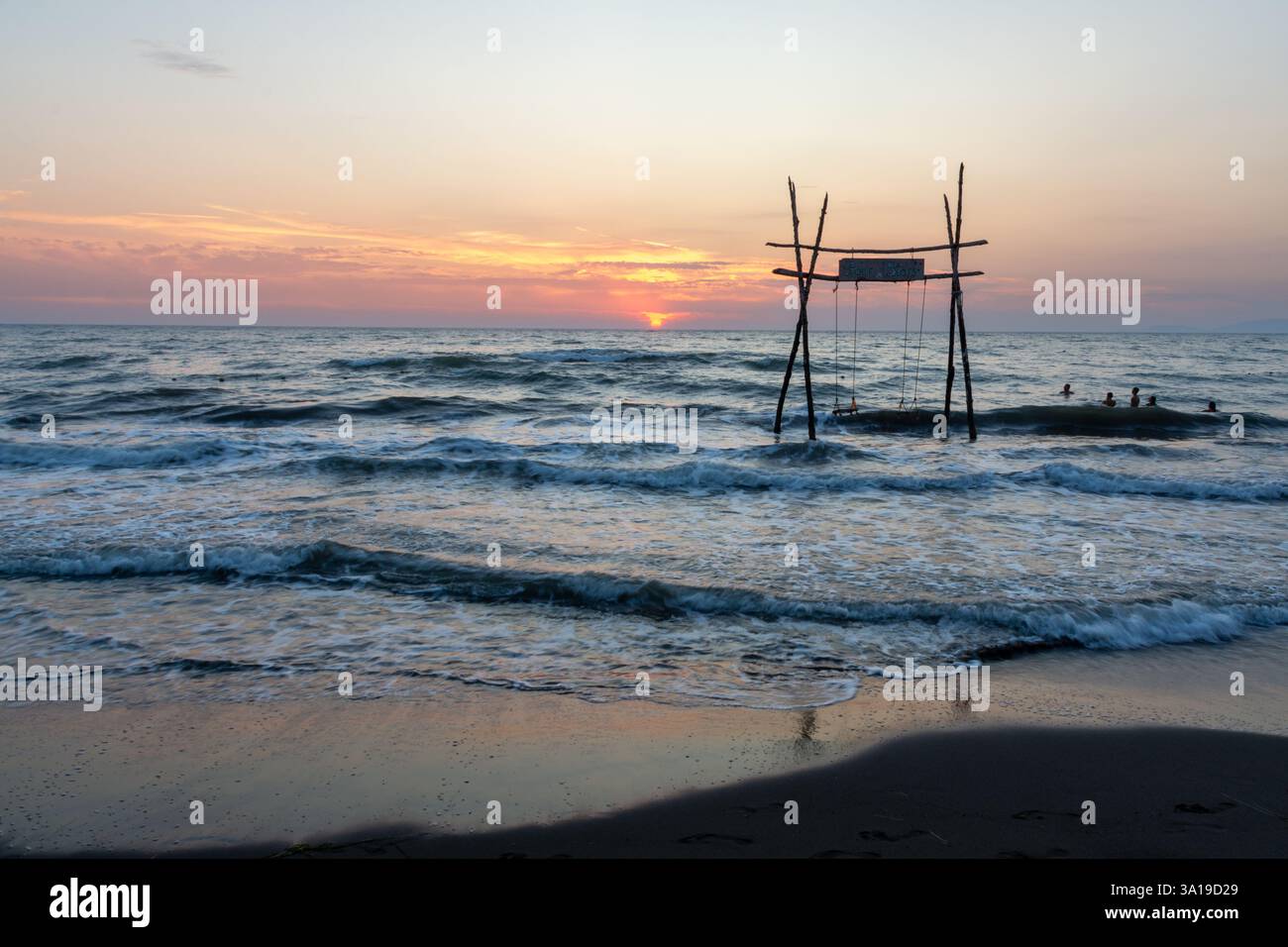 Seaside swing at sunset in Tale, Albania Stock Photo - Alamy