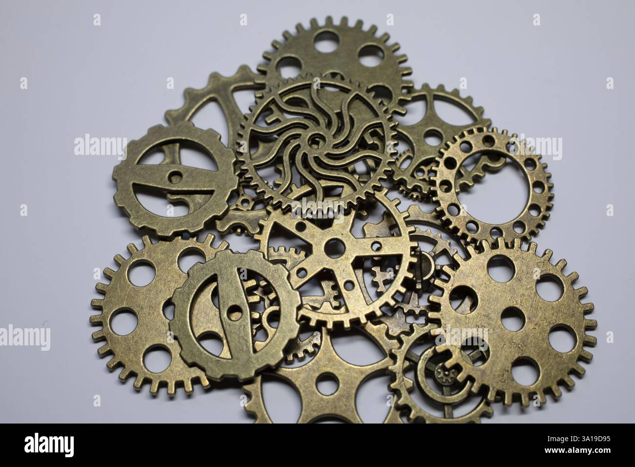 Brass gears are toothed together and form a gear wheel or clockwork ...